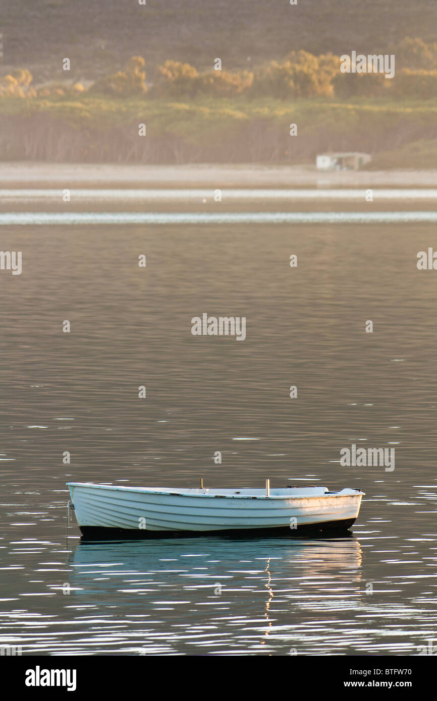 single white boat with reflections Stock Photo - Alamy