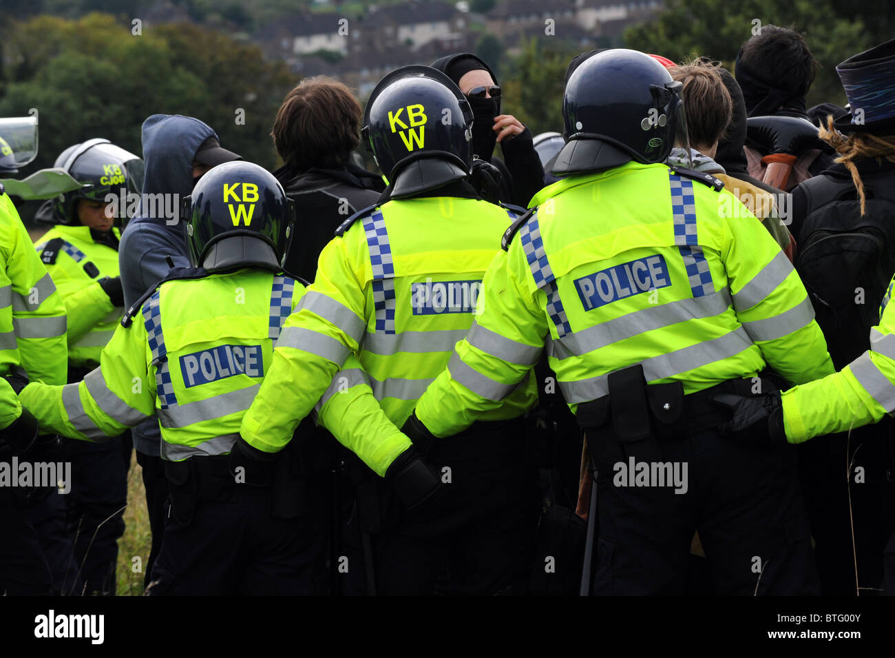 Police officers in riot gear link arms to kettle in protesters during a ...