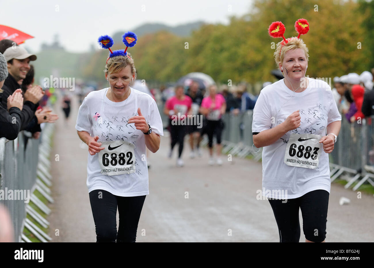 Runners with fancy dress in the rain at the Windsor Great Park half ...