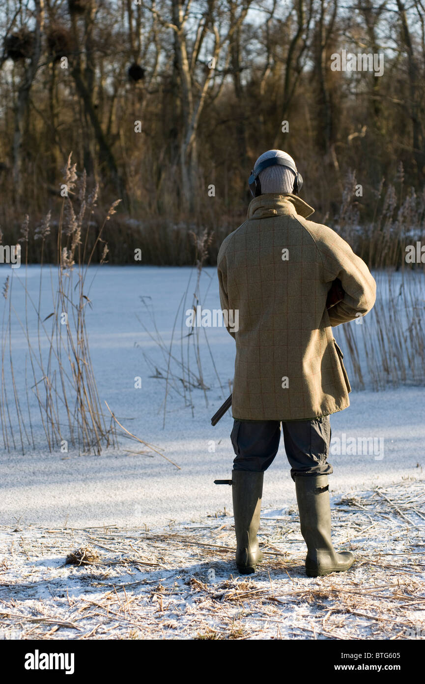 young man standing at shooting peg Stock Photo - Alamy