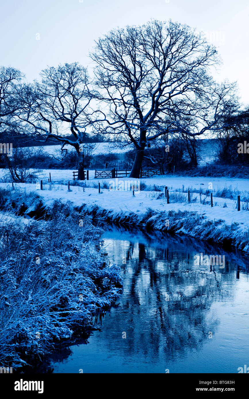A cold snow covered scene on the River Bure, Itteringham, Norfolk ...
