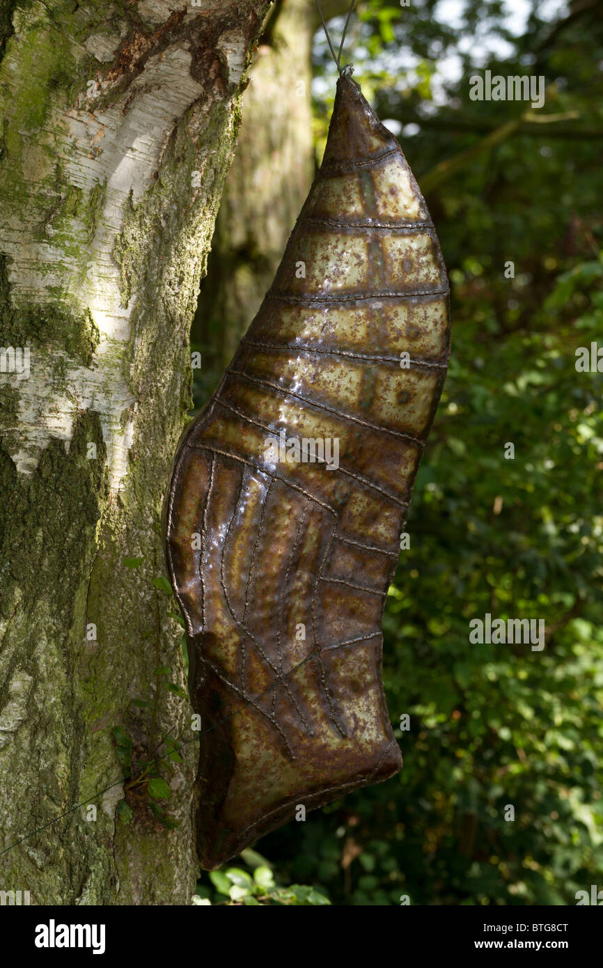 metalwork chrysalis sculpture mounted on a tree Stock Photo - Alamy