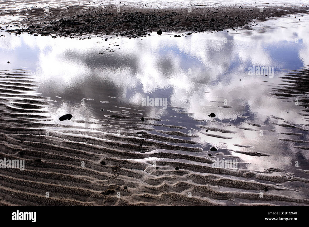 Reflections on a beach Stock Photo - Alamy
