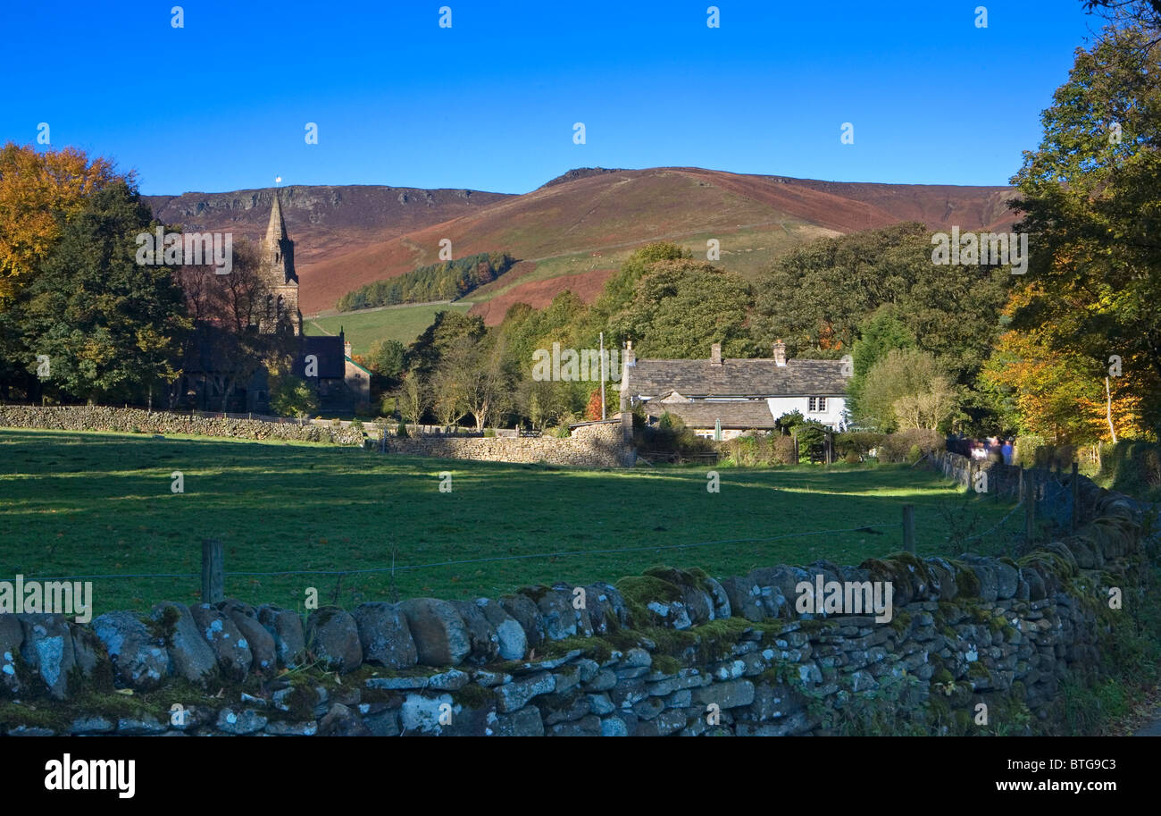 Edale church and village in autumn with Kinder Scout in the background ...