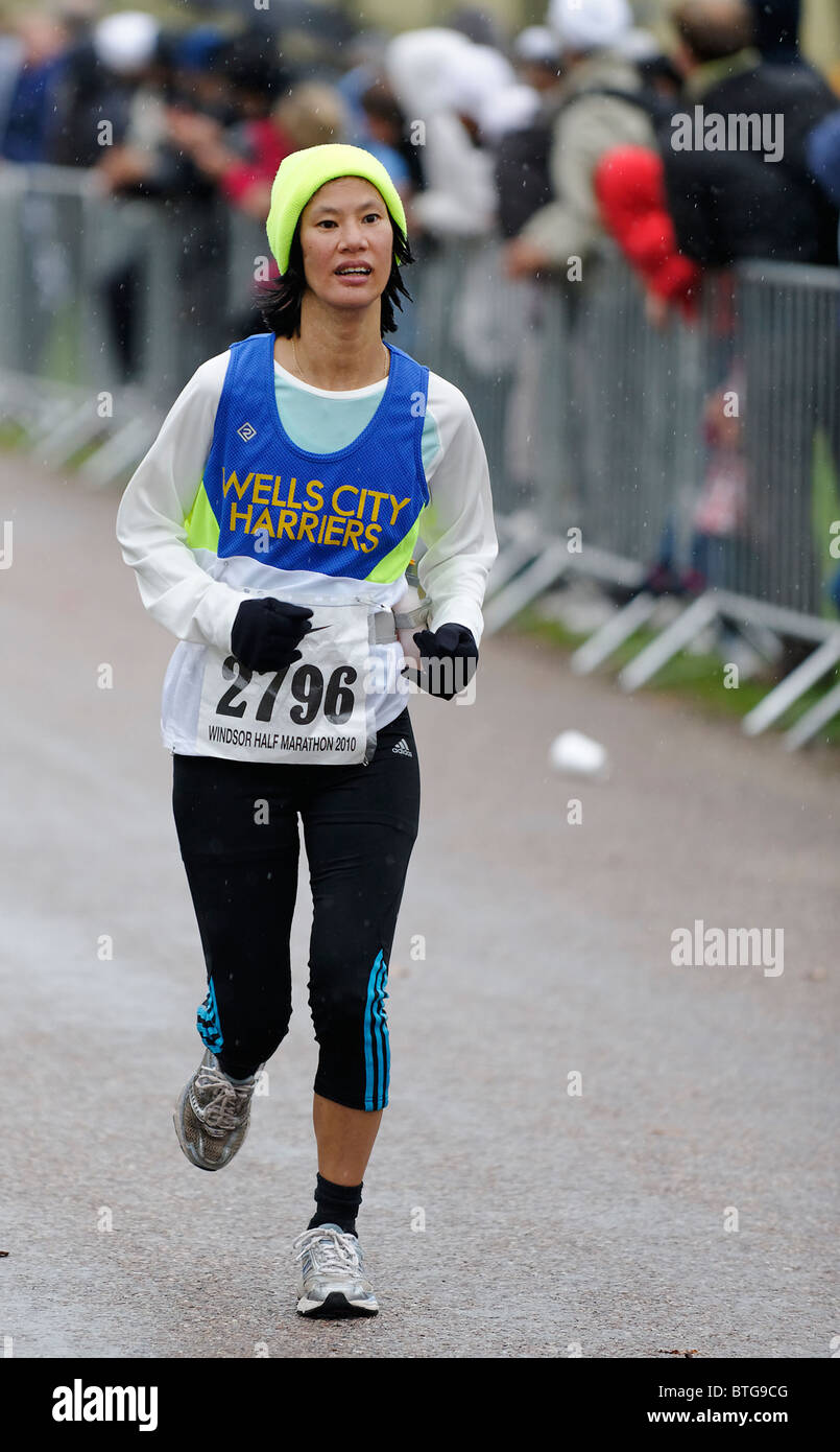 Asian woman running in rain hi-res stock photography and images - Alamy