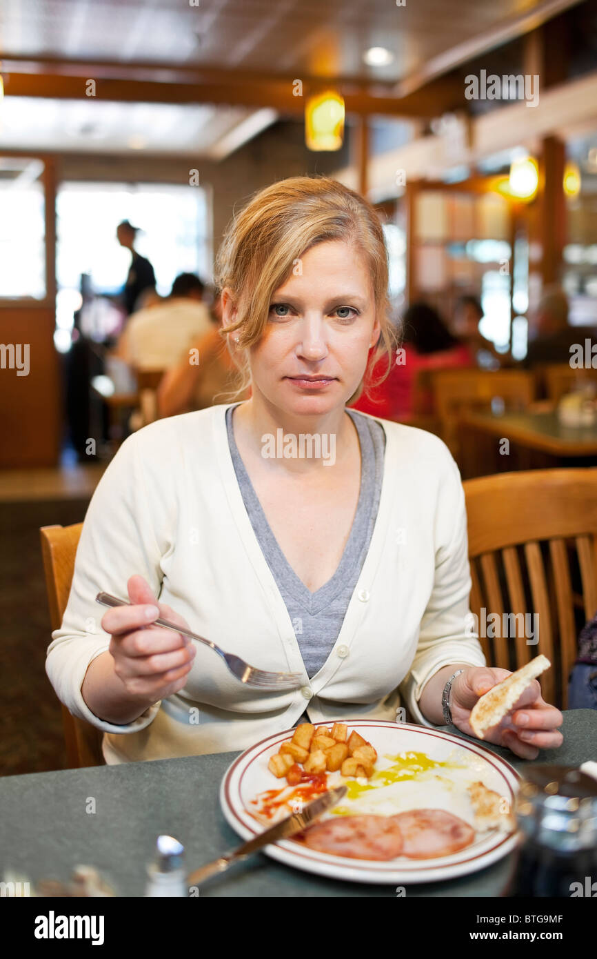 Woman eating breakfast at a diner. Winnipeg, Manitoba, Canada Stock ...