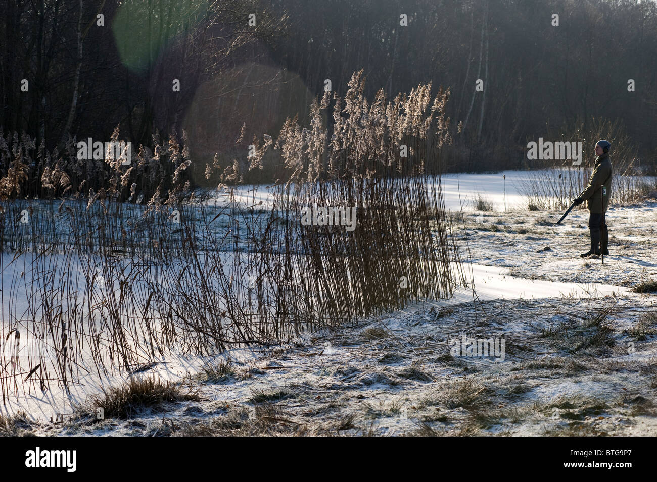 young man standing at shooting peg Stock Photo - Alamy