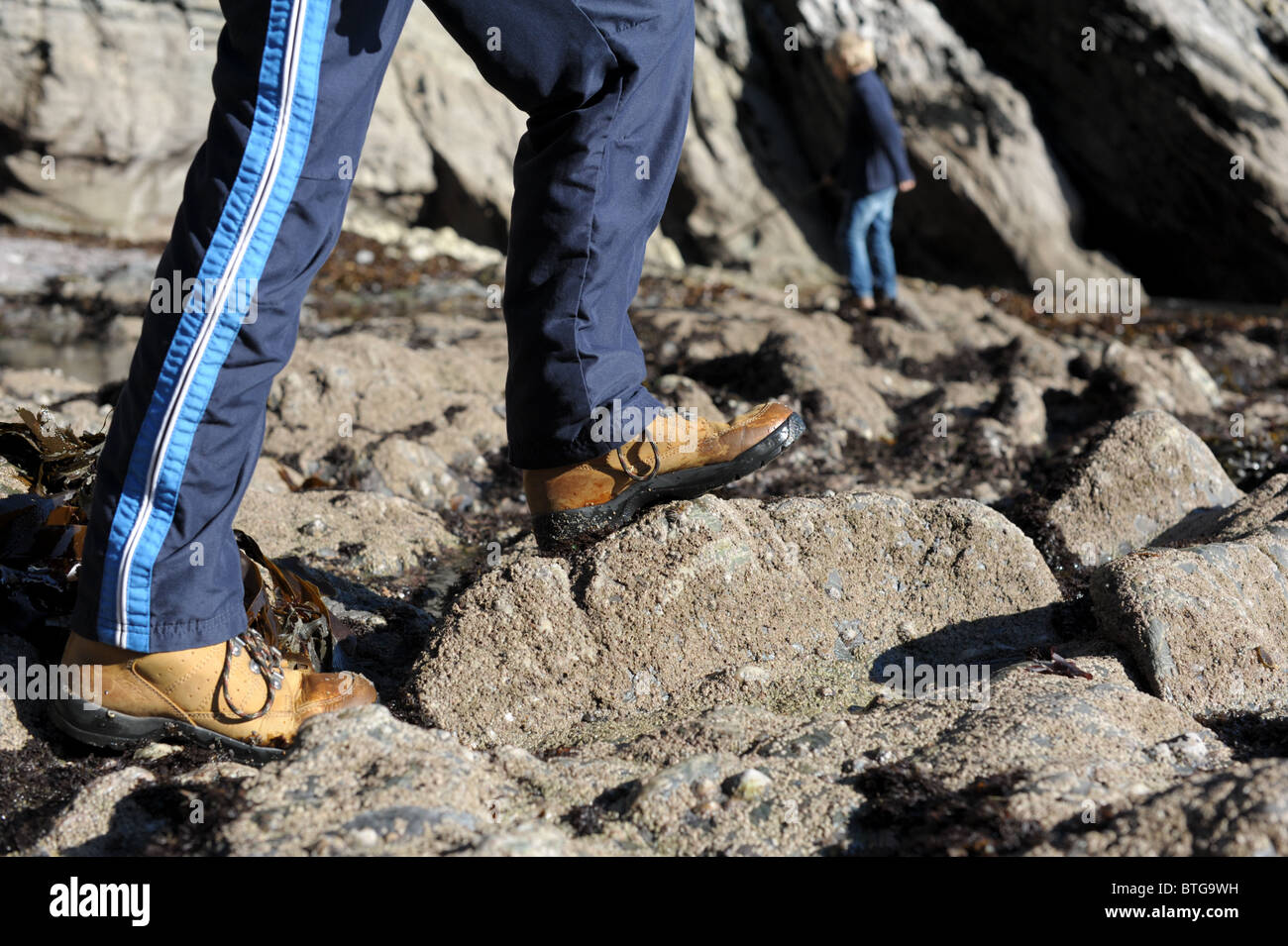 Two children playing on rocks hi-res stock photography and images - Alamy