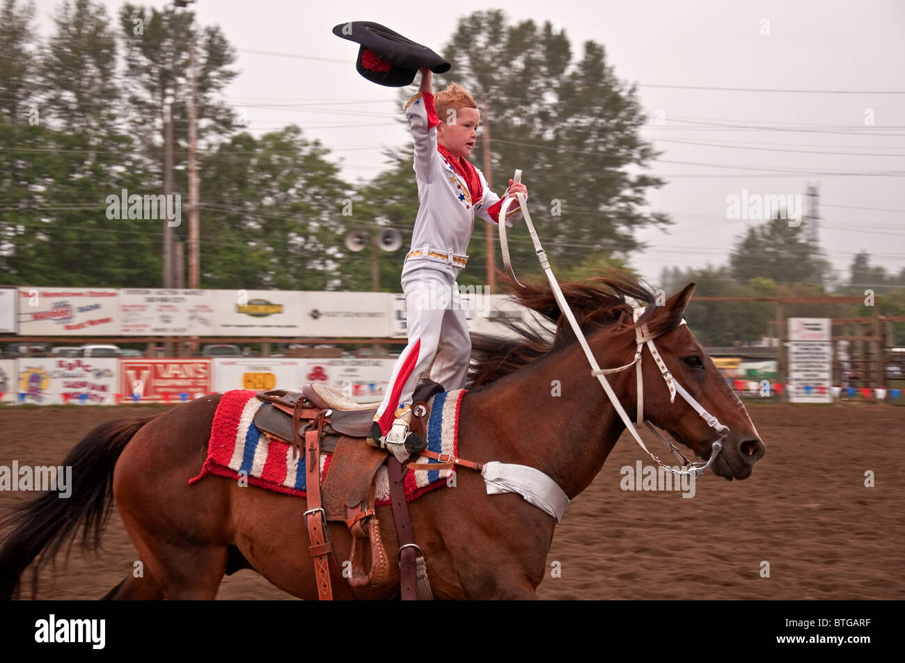 This young 6 year old boy is trick riding this beautiful brown horse in ...