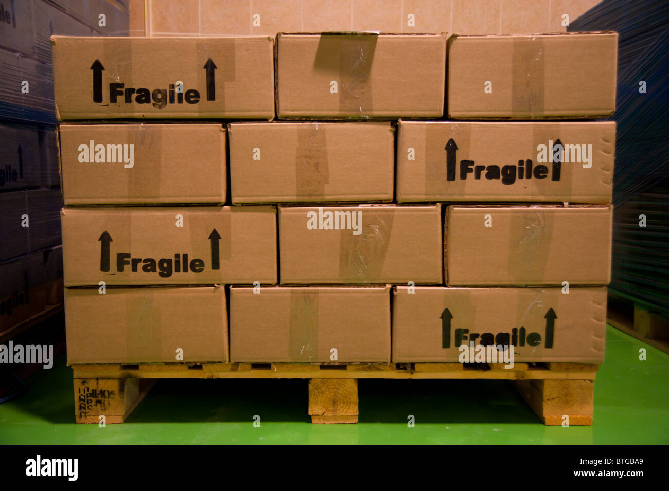 A stack of boxes on a wooden palette are labeled "fragile Stock Photo ...
