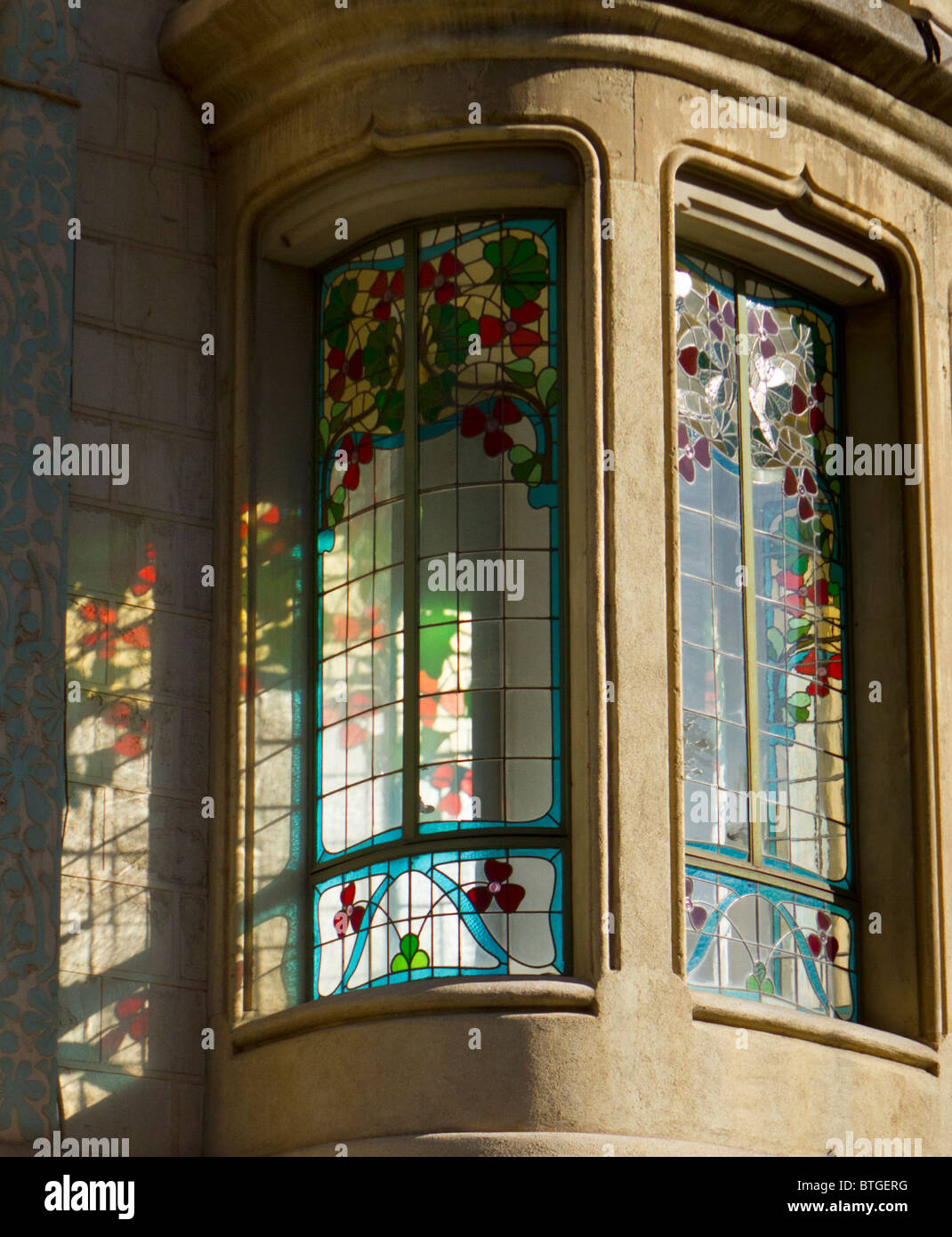 Detail Of An Apartment Building In Barcelona Showing Stained Glass In A Bay Window With A
