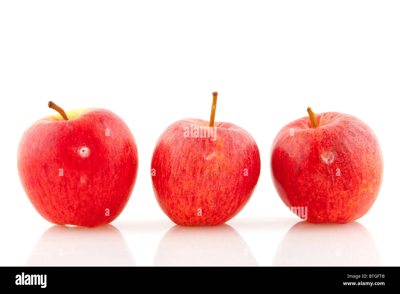Three red apples in a row isolated over white background Stock Photo ...