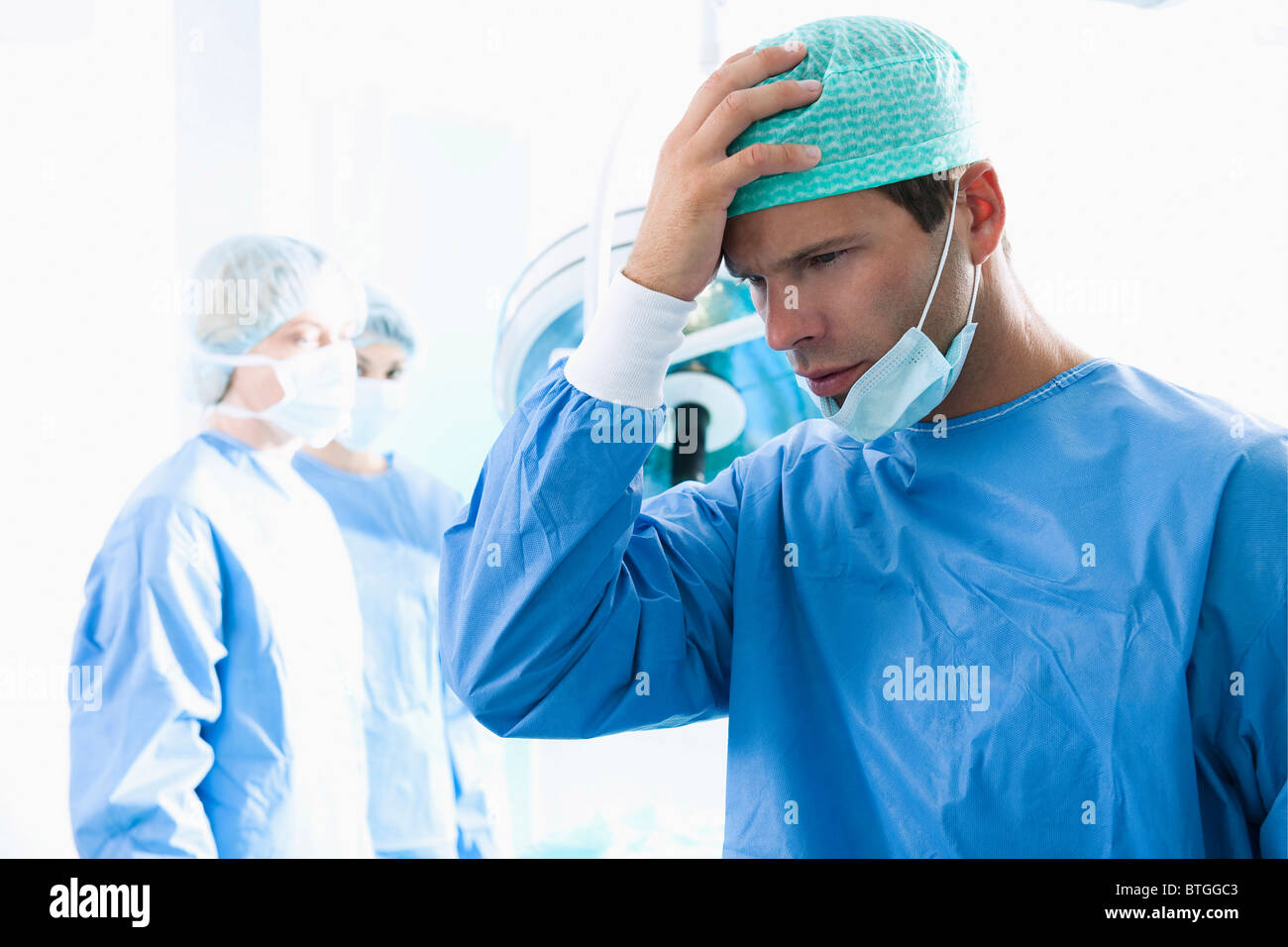Surgeon under stress in operating room Stock Photo - Alamy