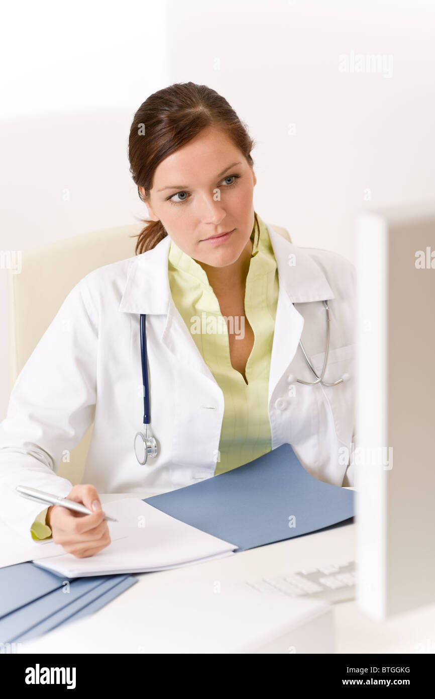 Female doctor write notes at medical office Stock Photo - Alamy