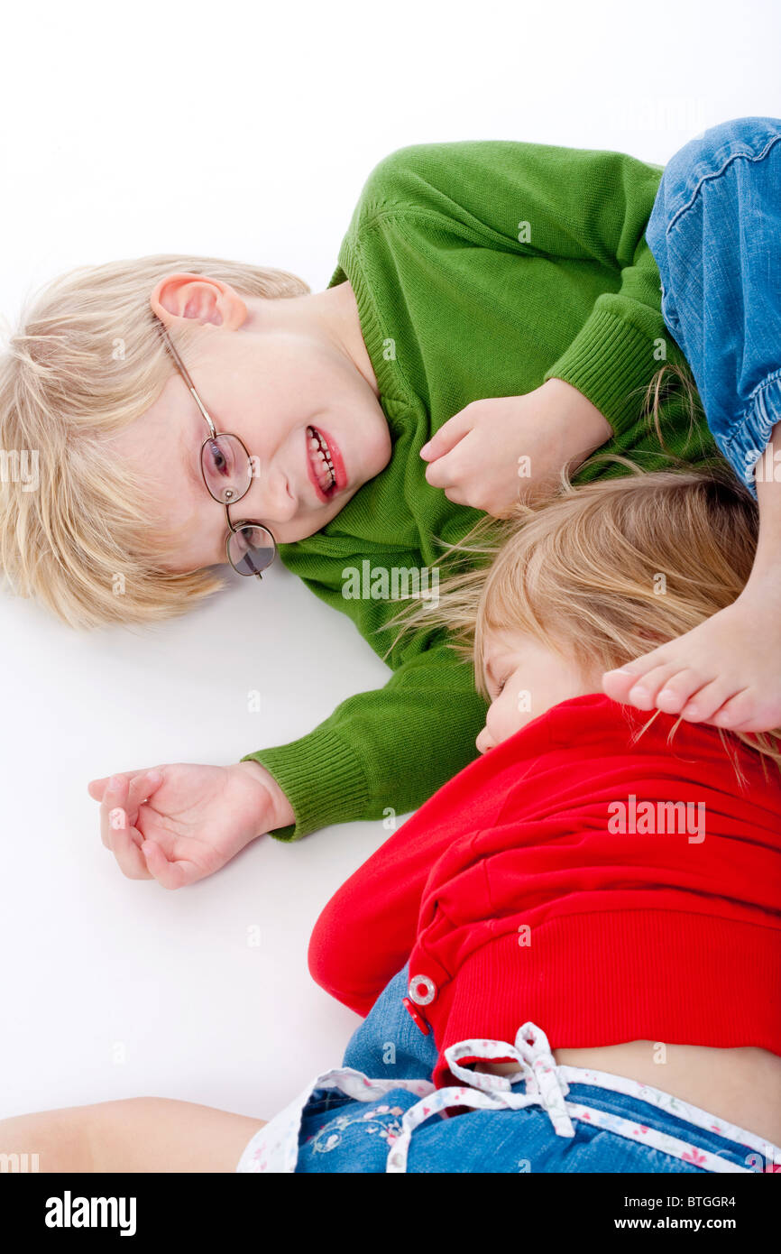two young siblings fooling around with each other - isolated on white ...