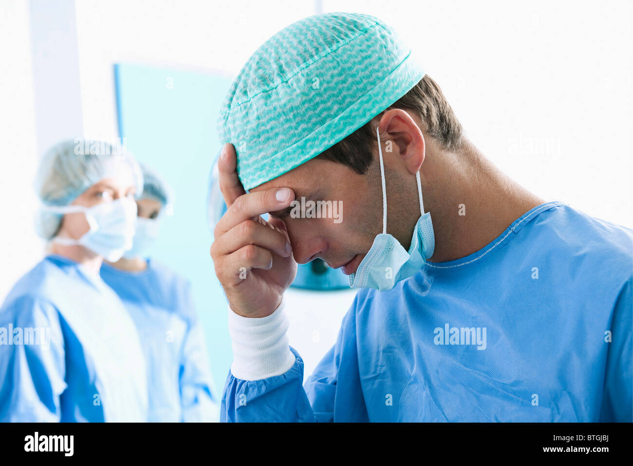 Surgeon under stress in operating room Stock Photo - Alamy