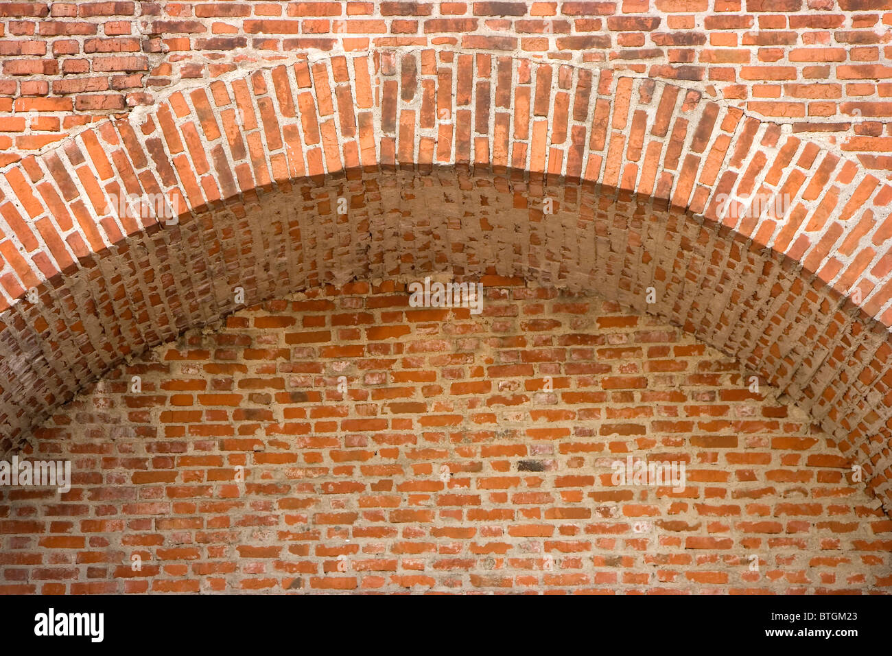 Arch photo in a wall from a red brick Stock Photo - Alamy