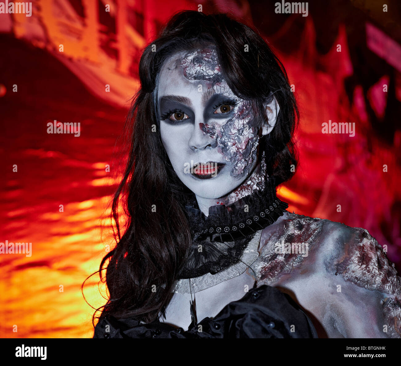 Zombie woman. Halloween. Female zombie against a wall of fire. Thailand ...