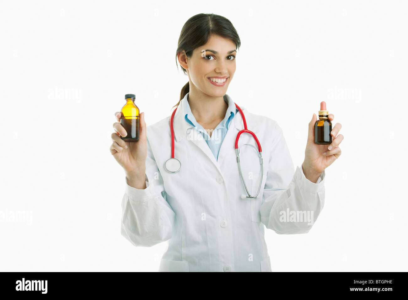 Doctor holding medicine bottles Stock Photo - Alamy