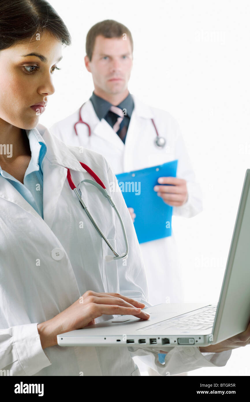 Doctor with laptop computer and doctor with medical chart Stock Photo ...