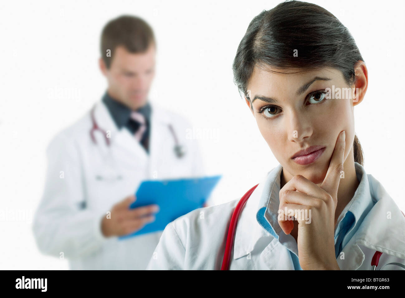 Doctor thinking and doctor reading medical chart Stock Photo - Alamy