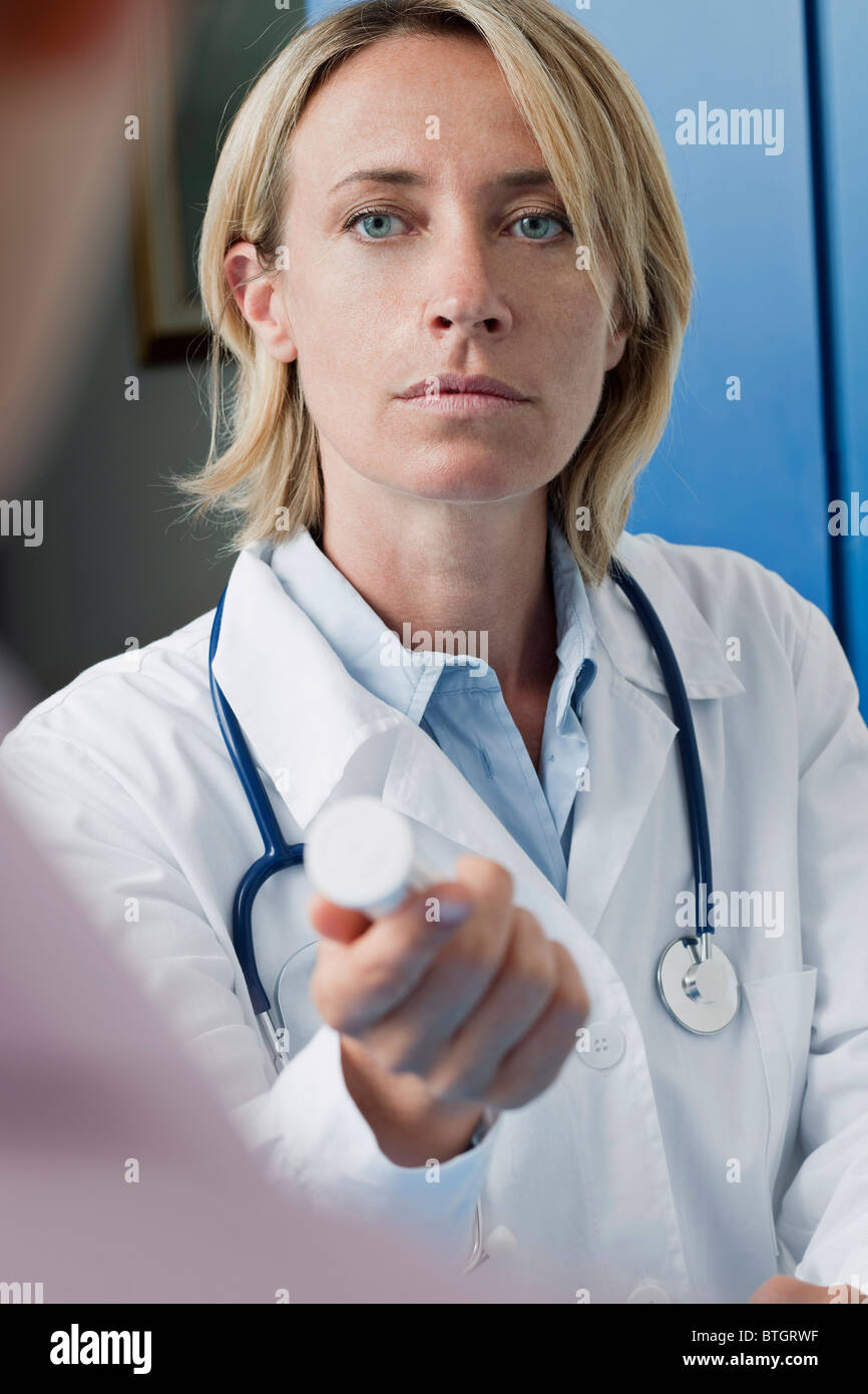 Doctor giving patient medicine Stock Photo - Alamy