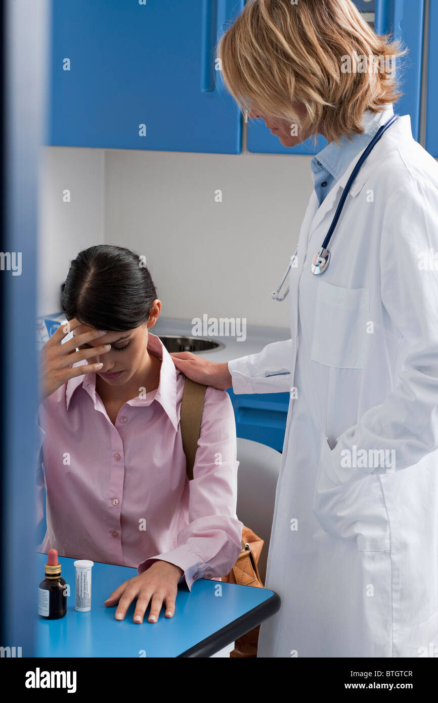 Doctor consoling patient Stock Photo - Alamy