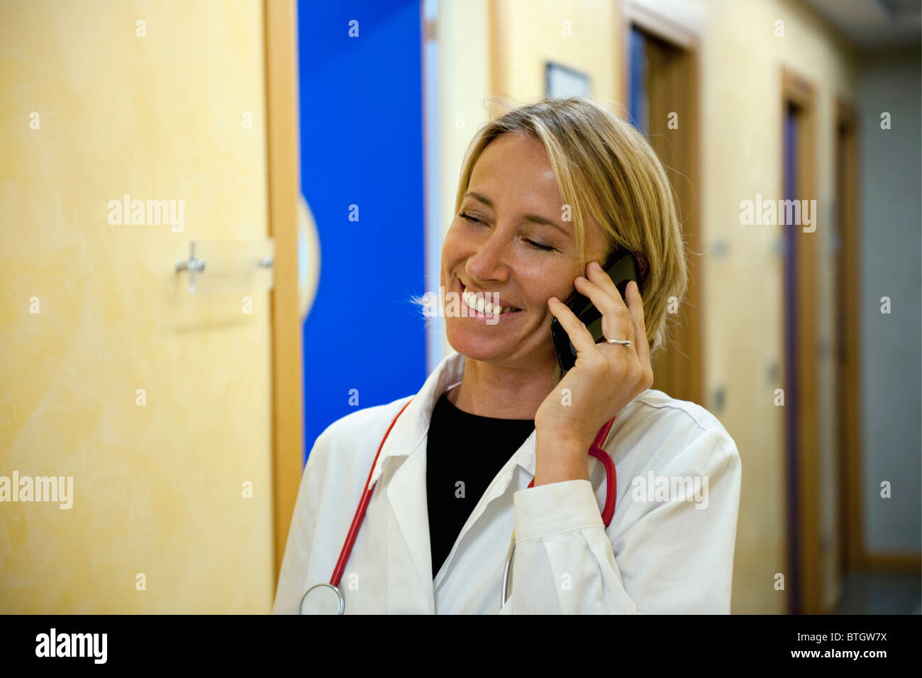 Doctor making telephone call in medical center Stock Photo - Alamy