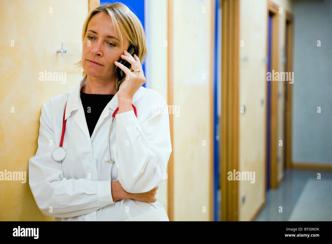 Doctor making telephone call in medical center Stock Photo - Alamy