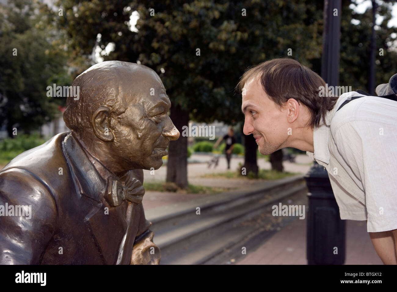 The young man looks in the face to a statue Stock Photo - Alamy