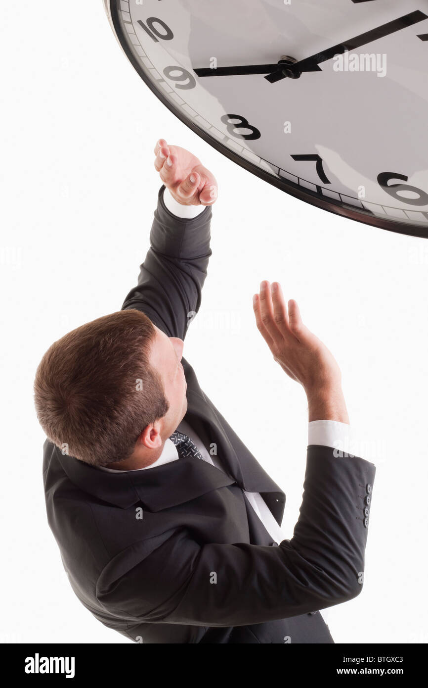 Man underneath clock Stock Photo - Alamy