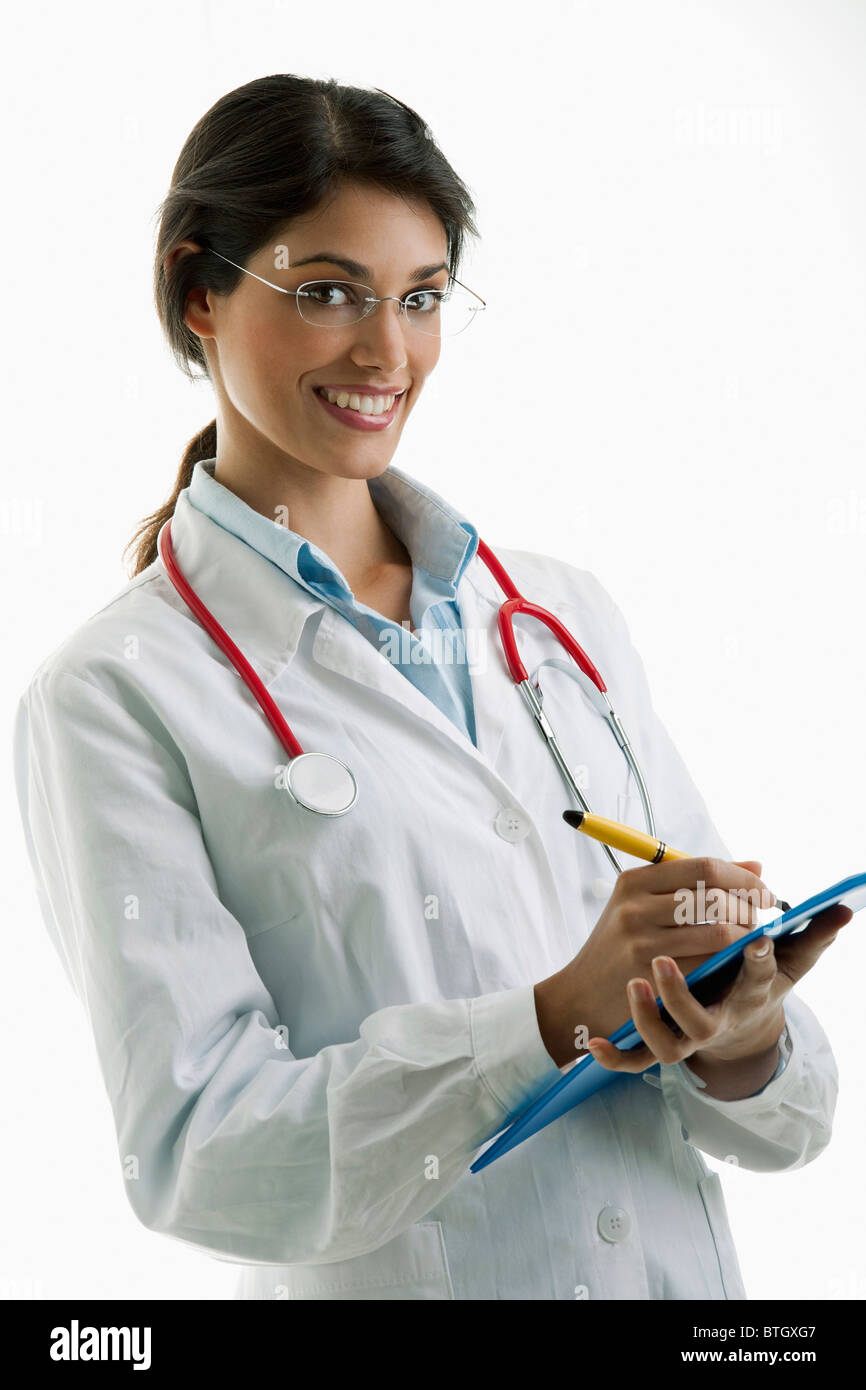 Doctor wearing stethoscope and writing on chart Stock Photo - Alamy