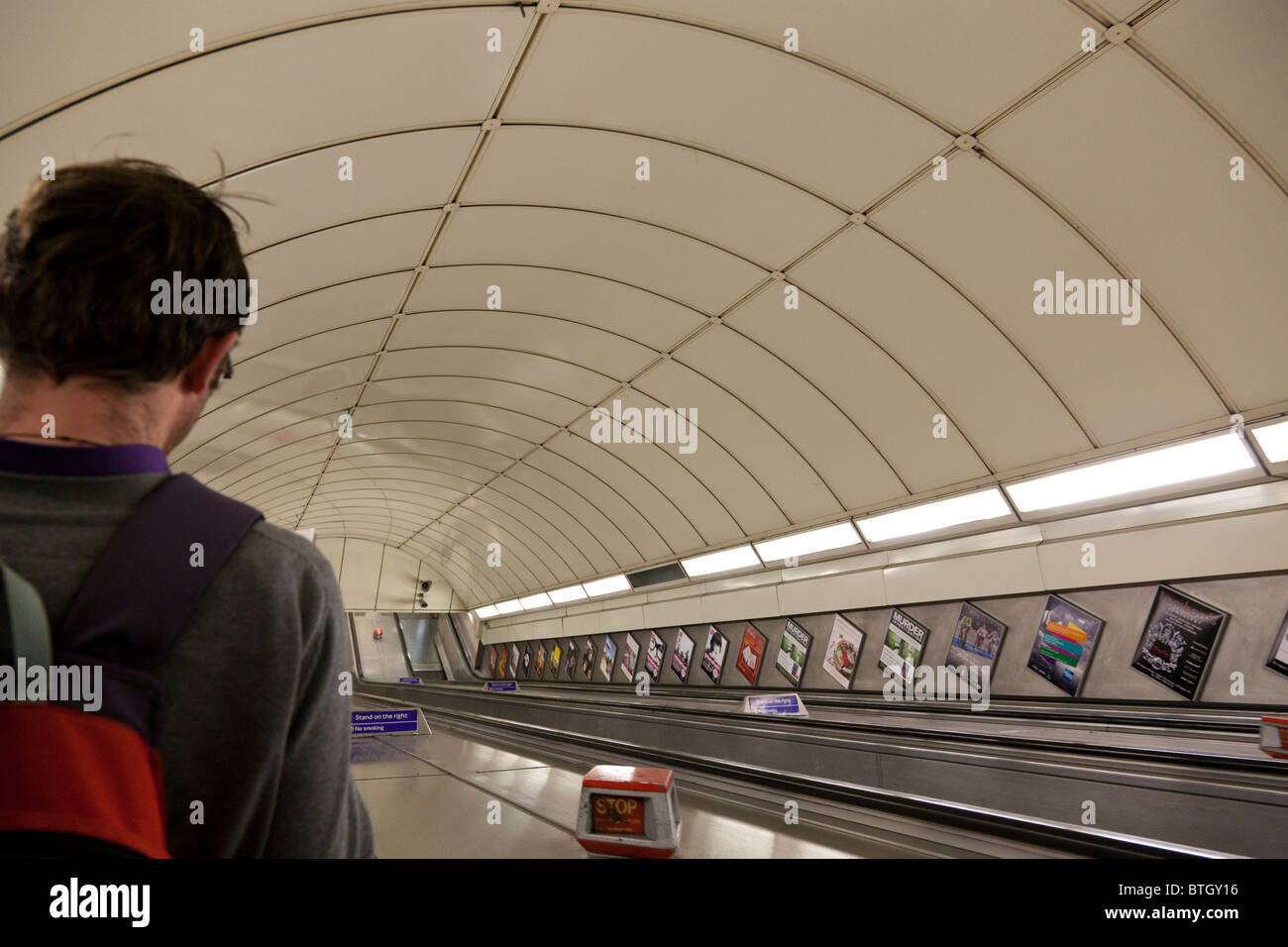 Descending an escalator on the underground tube system in London ...