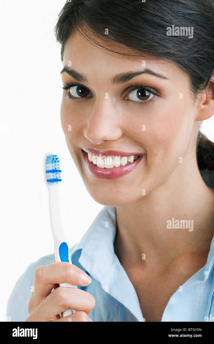 Young woman holding toothbrush Stock Photo - Alamy