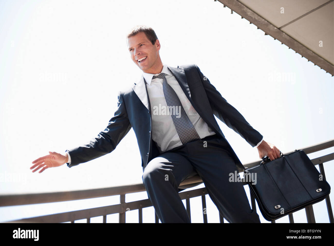 Businessman sliding down railing hi-res stock photography and images ...