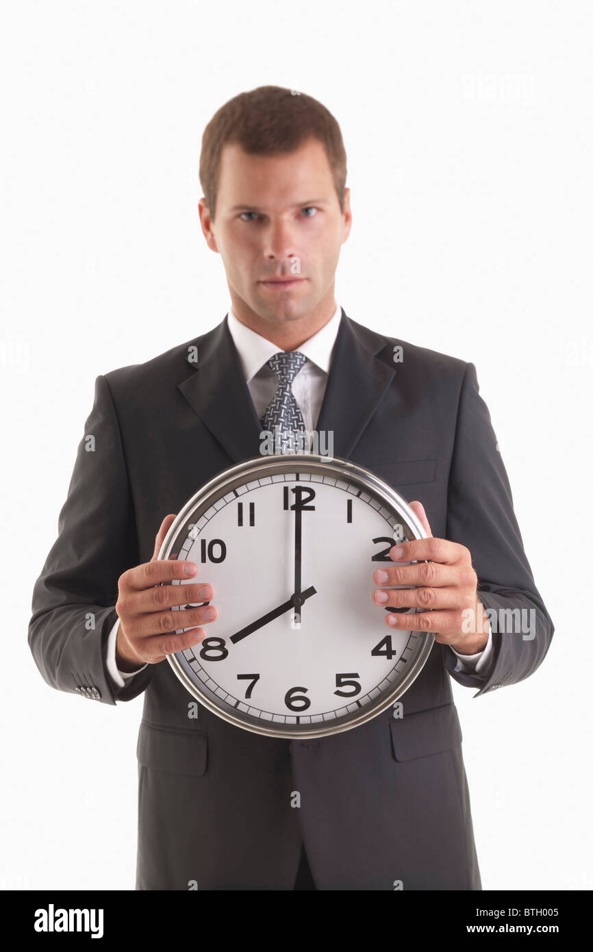 Man holding clock Stock Photo - Alamy