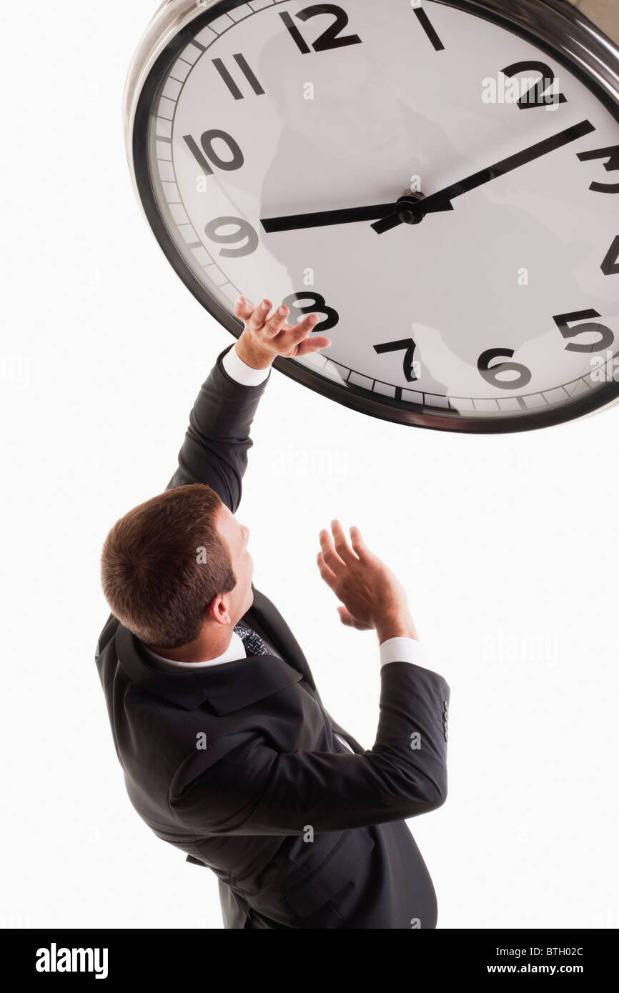 Man underneath clock Stock Photo - Alamy