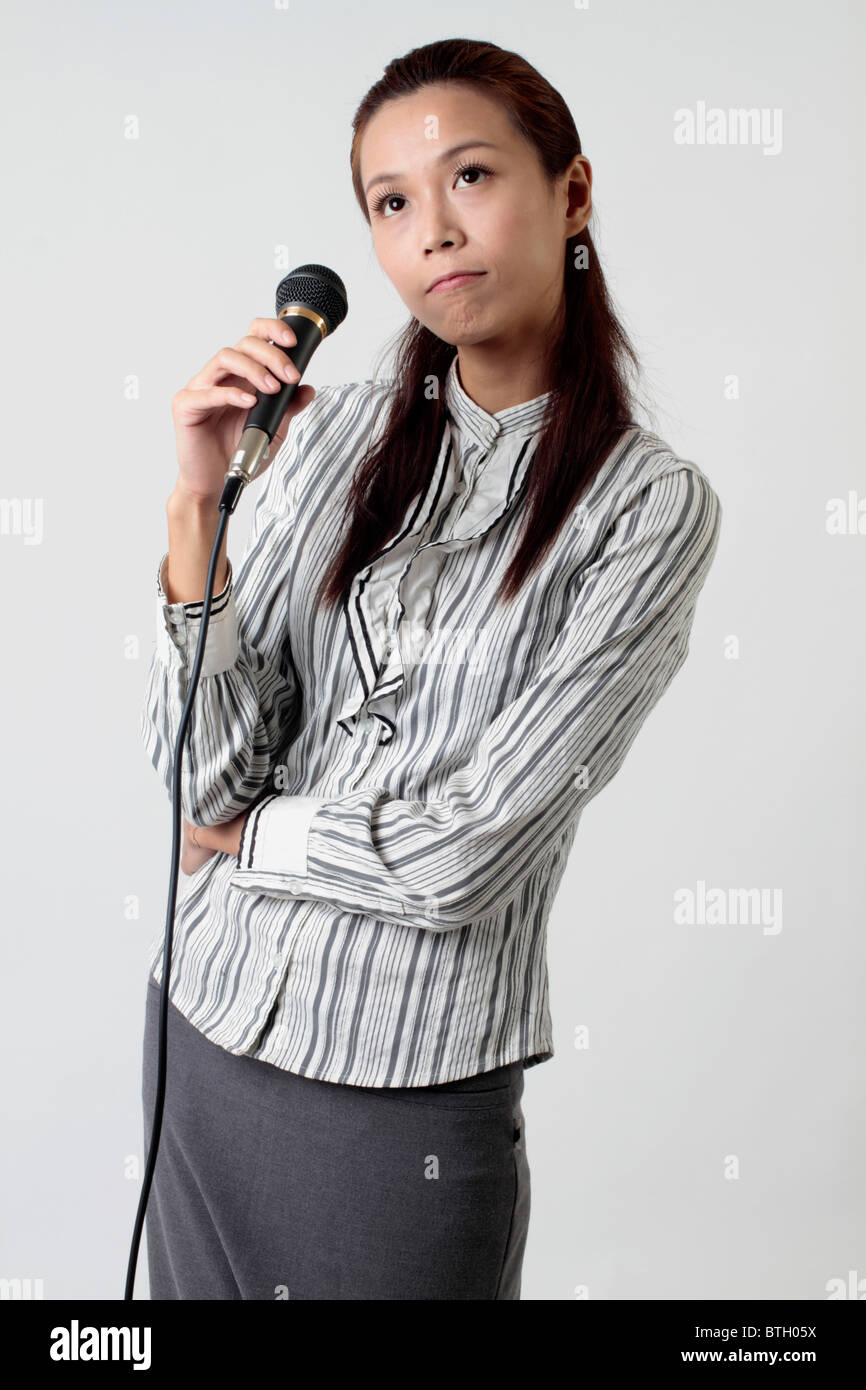 Office lady takes microphone and sings song Stock Photo - Alamy