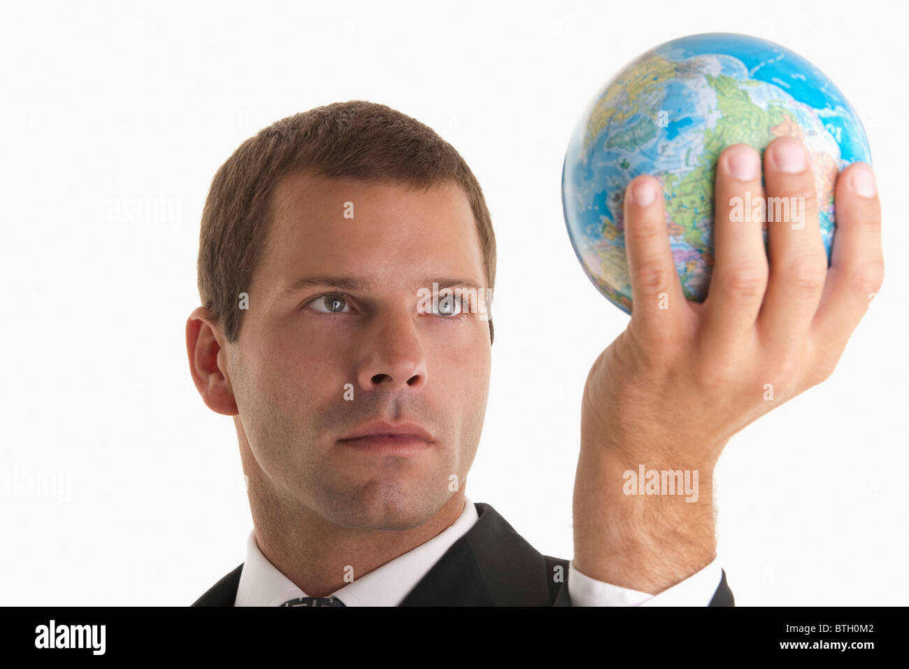 Man holding globe Stock Photo - Alamy