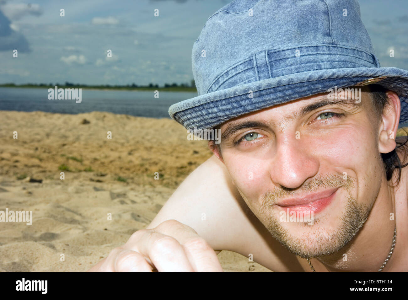Photo of the man lying on a beach Stock Photo - Alamy