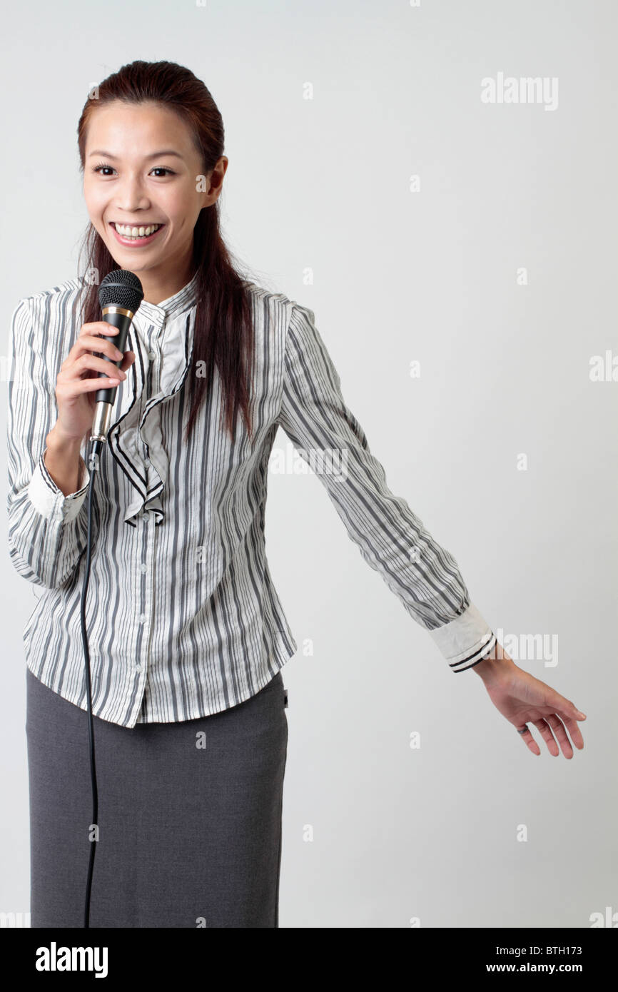 Office lady takes microphone and sings song Stock Photo - Alamy