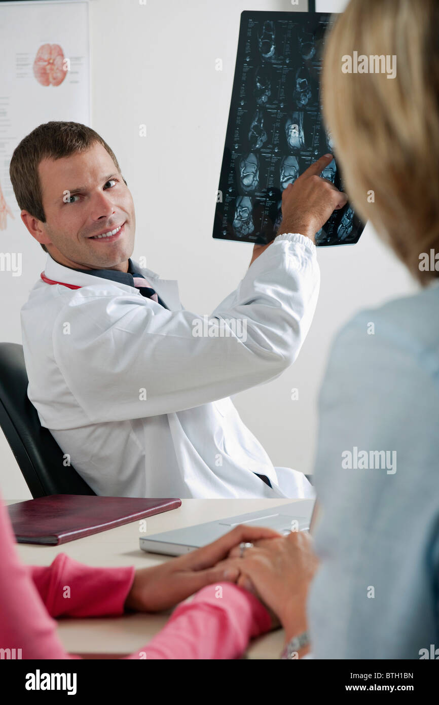 Doctor showing MRI to patient Stock Photo - Alamy