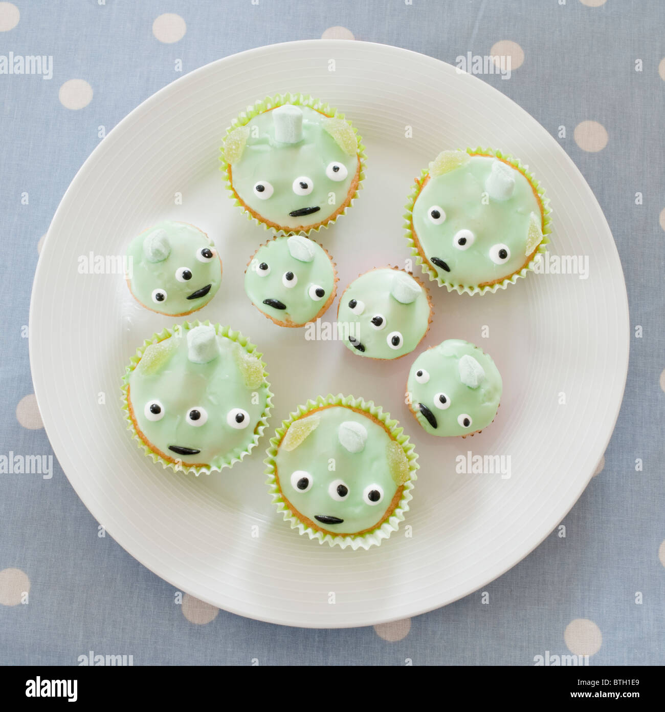 A plate of green alien iced homemade buns for a childs birthday party ...