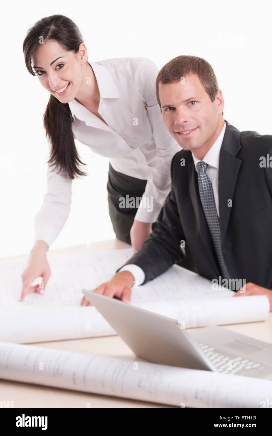 Man and woman looking over plans at desk Stock Photo - Alamy