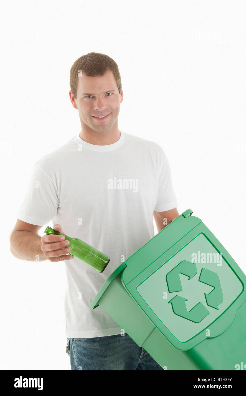 Man throwing glass bottle in the recycling bin Stock Photo - Alamy