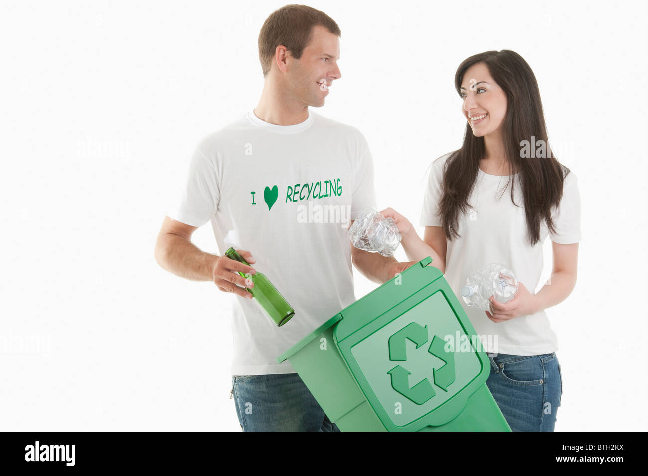 Couple throwing glass and plastic bottles in the recycling bin Stock ...