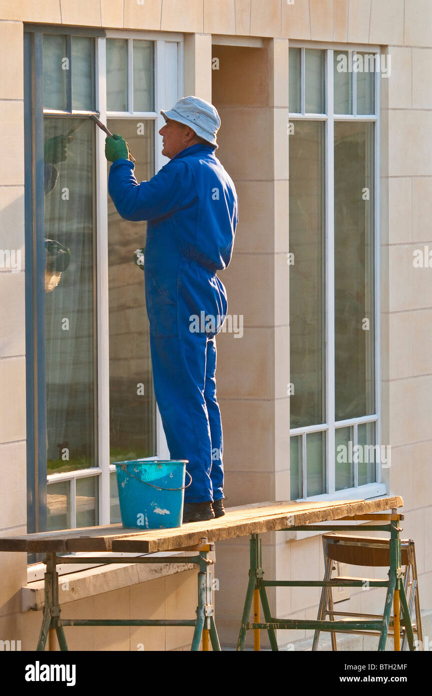 Man painting shop window France Stock Photo - Alamy