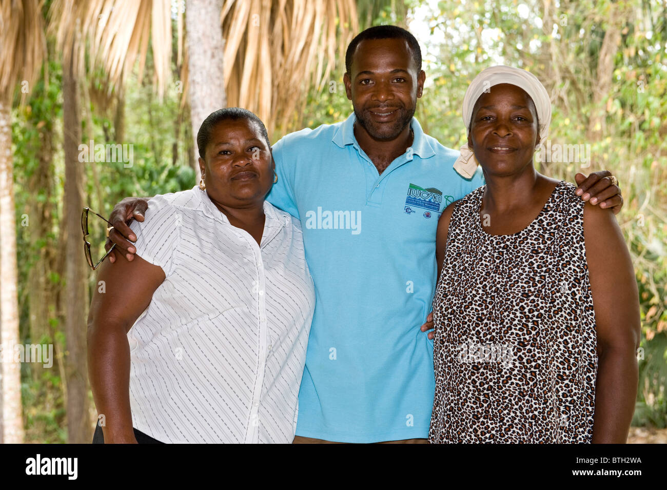 Three people standing together forest on the background St. Lucia ...