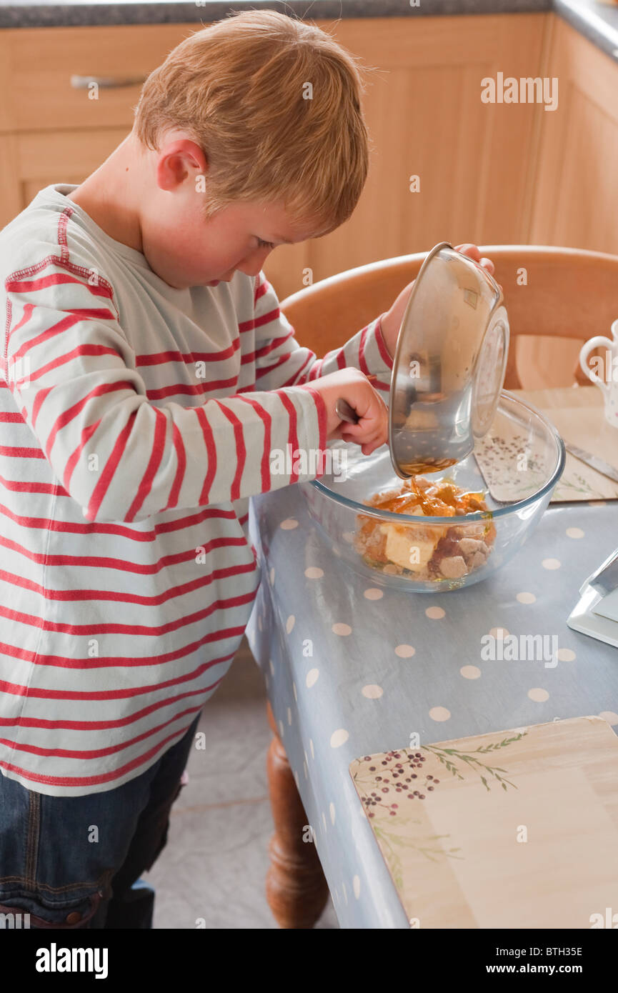 A MODEL RELEASED photo of a seven year old boy preparing cooking ...