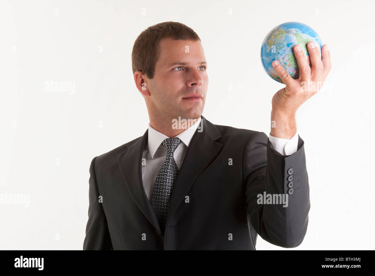 Man holding globe Stock Photo - Alamy